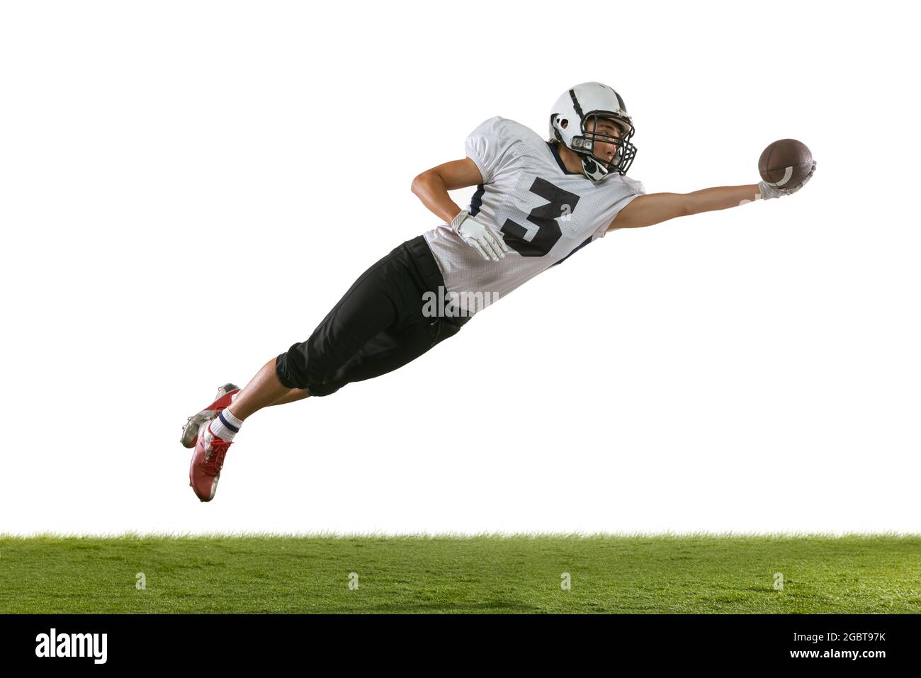 Portrait of American football player training isolated on white studio ...