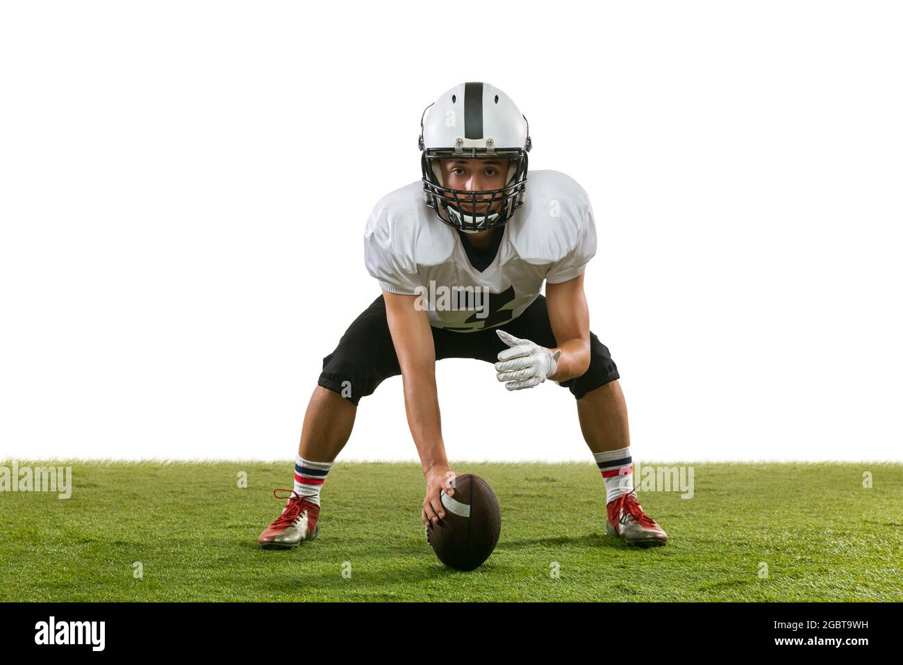 Portrait of American football player training isolated on white studio ...