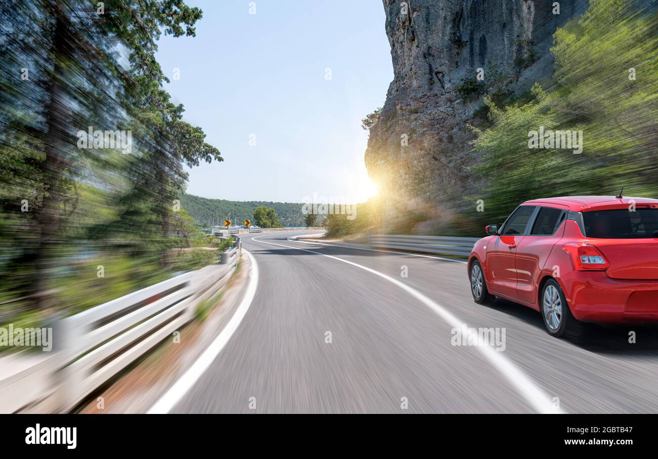 Red car on a scenic road Stock Photo - Alamy