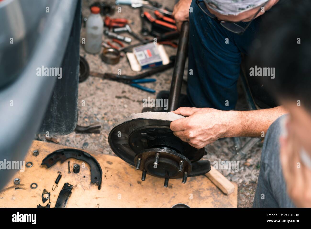 Auto mechanic repairing the brake system of car Stock Photo - Alamy
