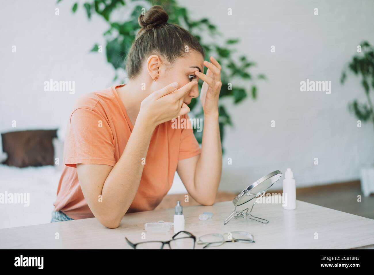 Young girl with poor eyesight puts on lens for vision Stock Photo - Alamy