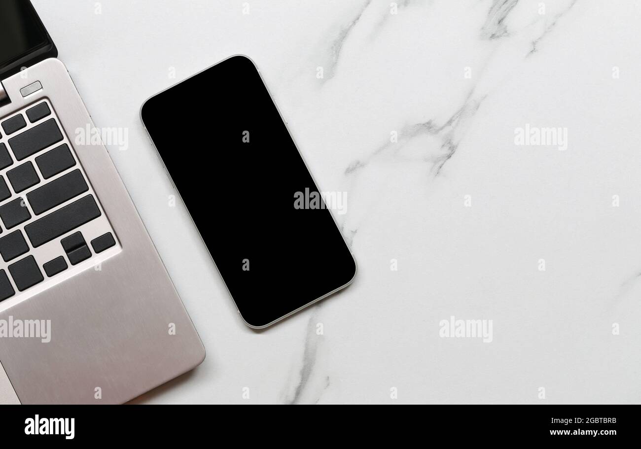 Smartphone of blank screen placed beside the notebook and have clipping ...