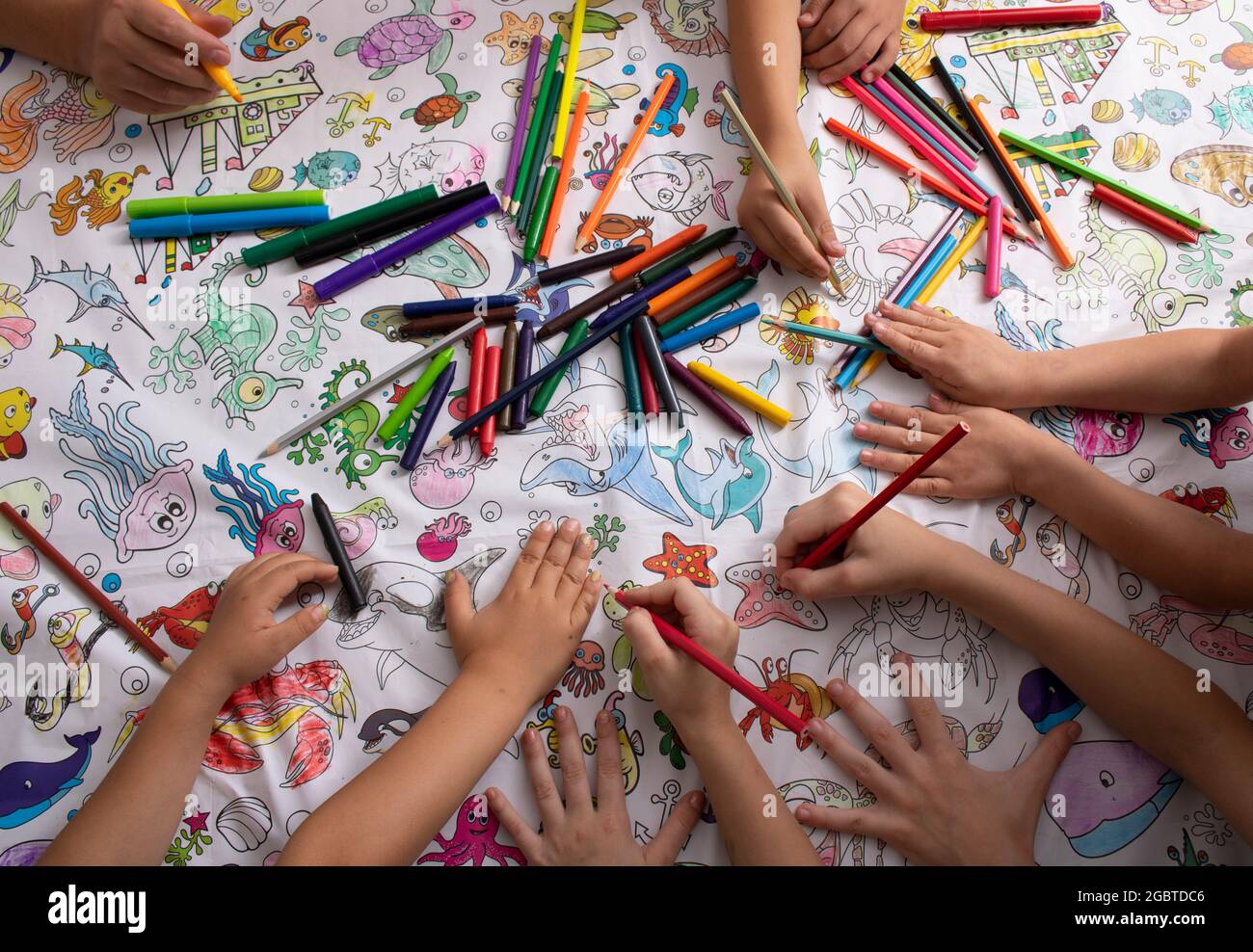 kids holding pencils and crayons, top view Stock Photo - Alamy