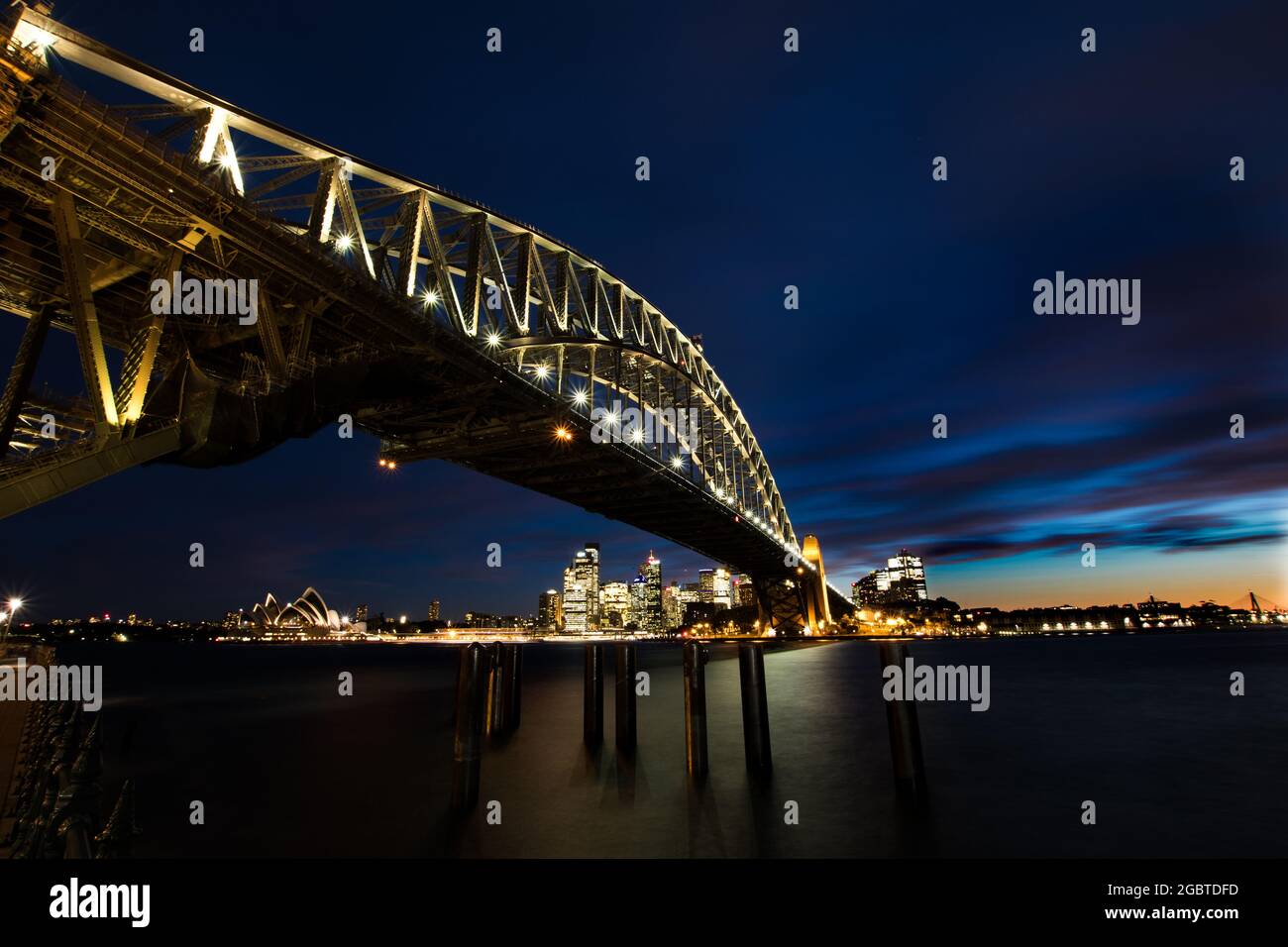 View of beautiful illuminated Sydney Harbour Bridge with arch-based ...