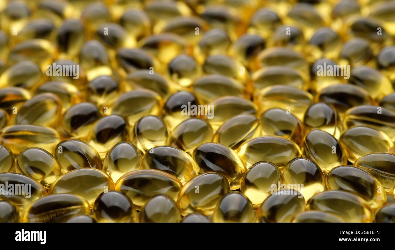 Golden softgel capsules. Omega 3 gold oil capsules top view. Supplement ...