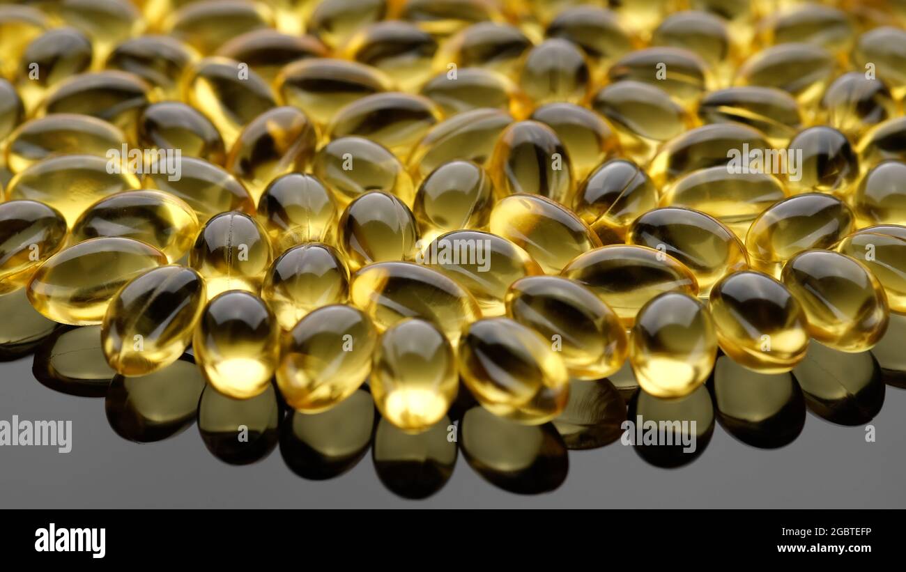 Golden softgel capsules. Omega 3 gold oil capsules top view. Supplement ...