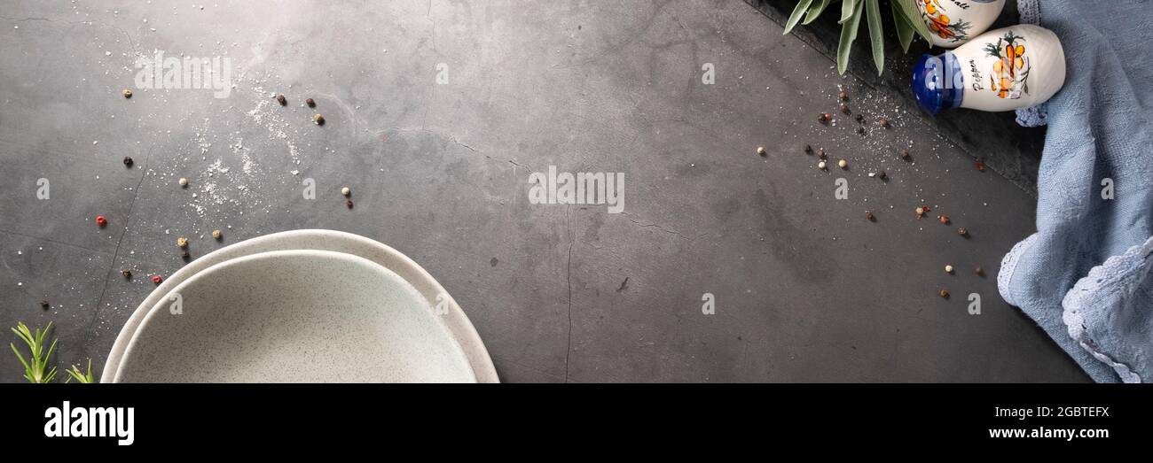 Dark food background with empty cement plate and spices Stock Photo - Alamy