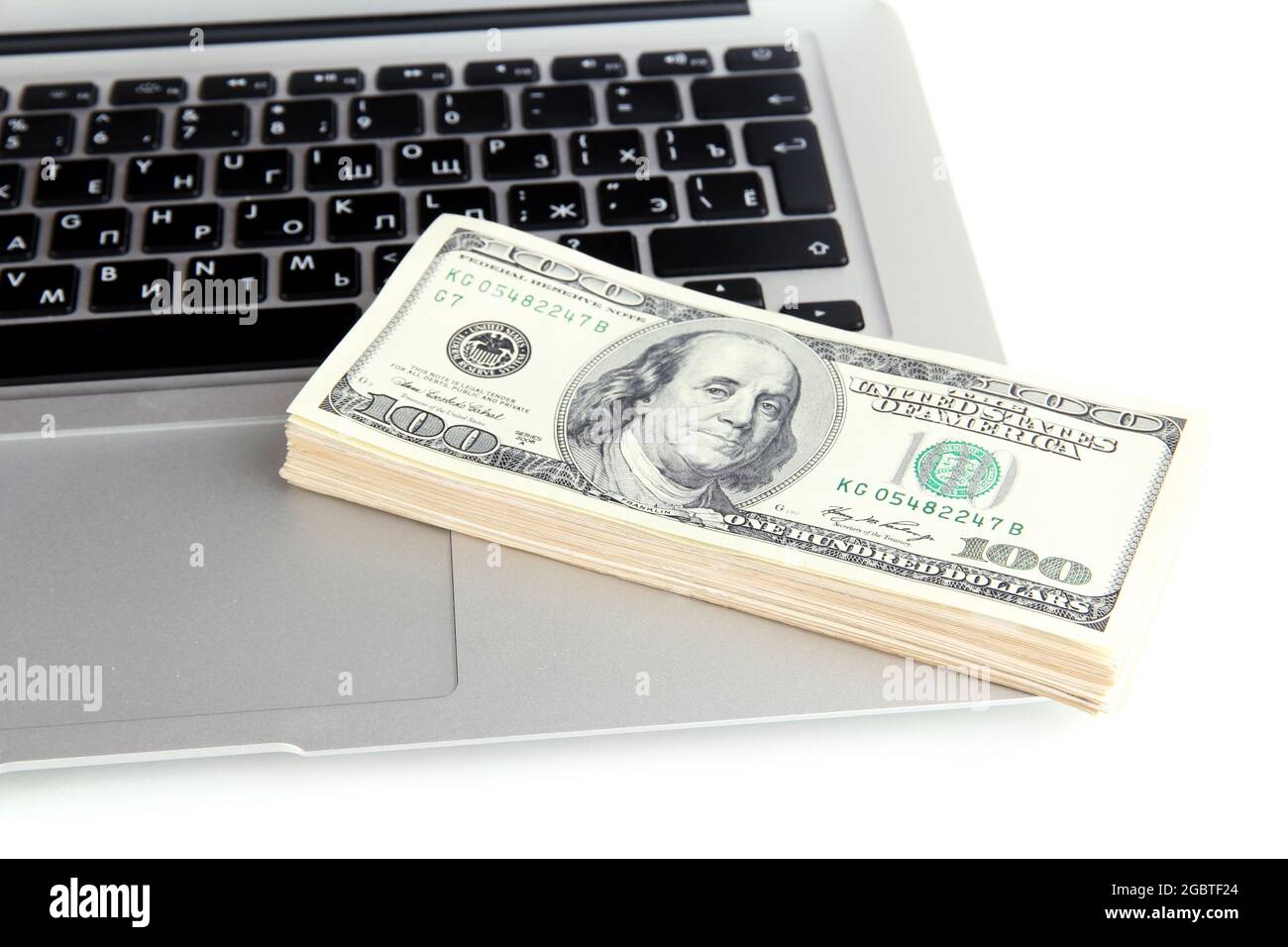 Money on laptop isolated on white Stock Photo - Alamy