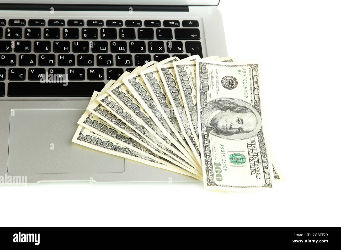 Money on laptop isolated on white Stock Photo - Alamy