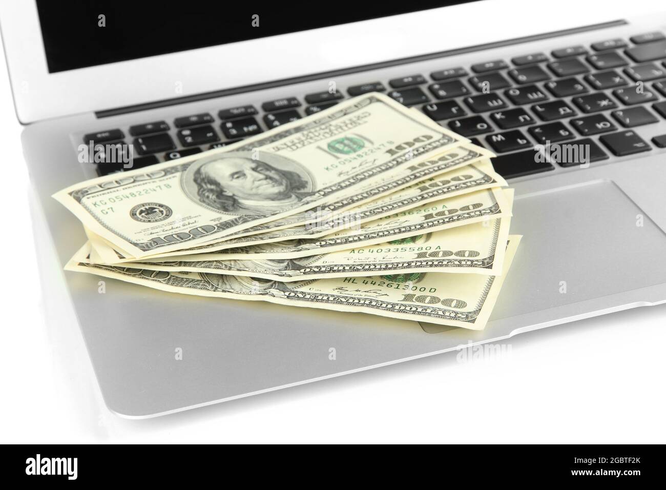 Money on laptop isolated on white Stock Photo - Alamy