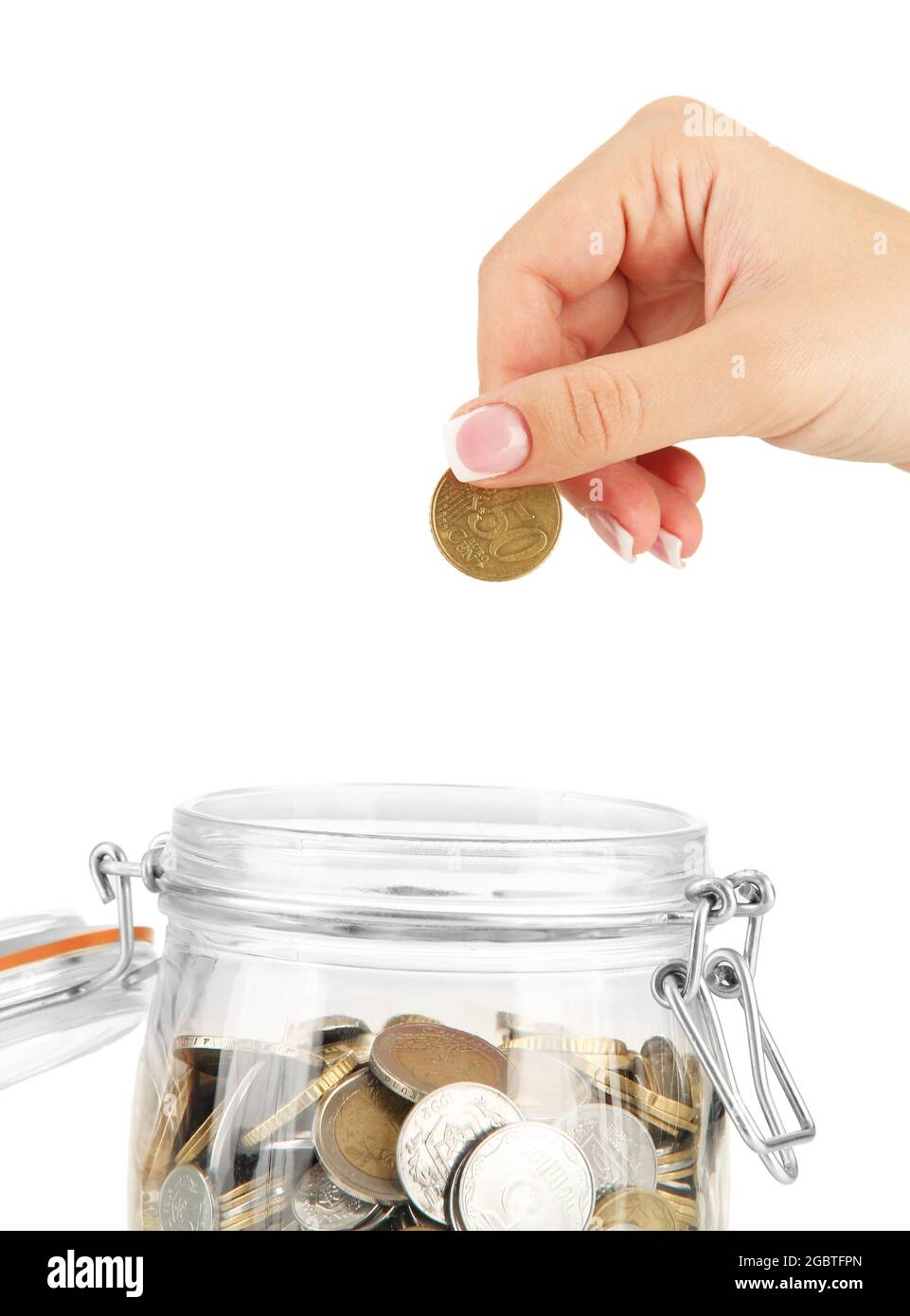 Saving, female hand putting a coin into glass bottle, isolated on white ...