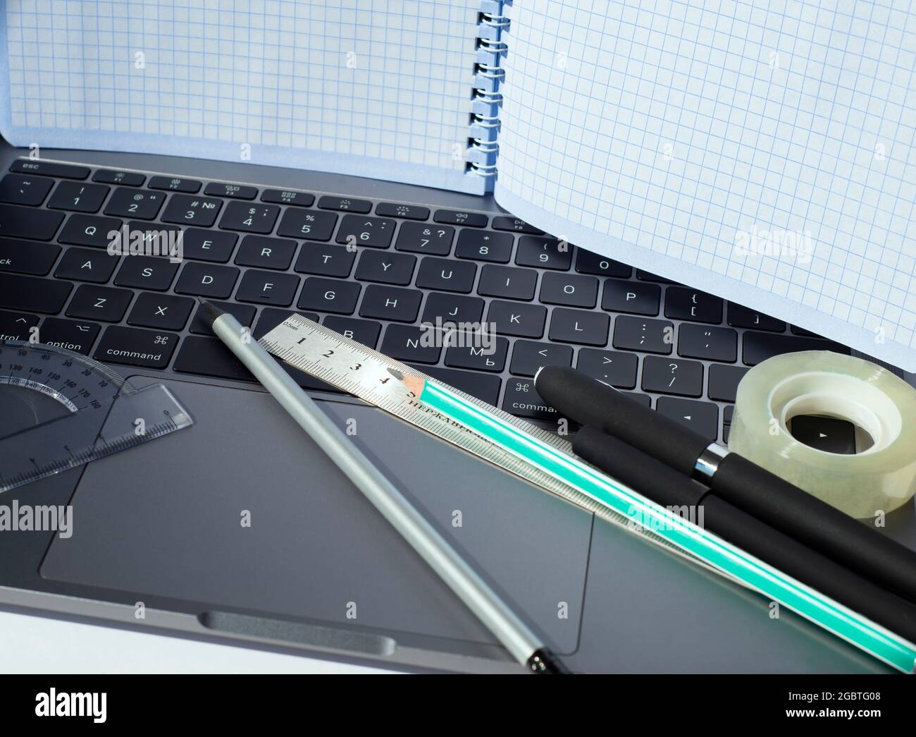 Notebook on the laptop screen. The sheets are turned over. Pencils ...