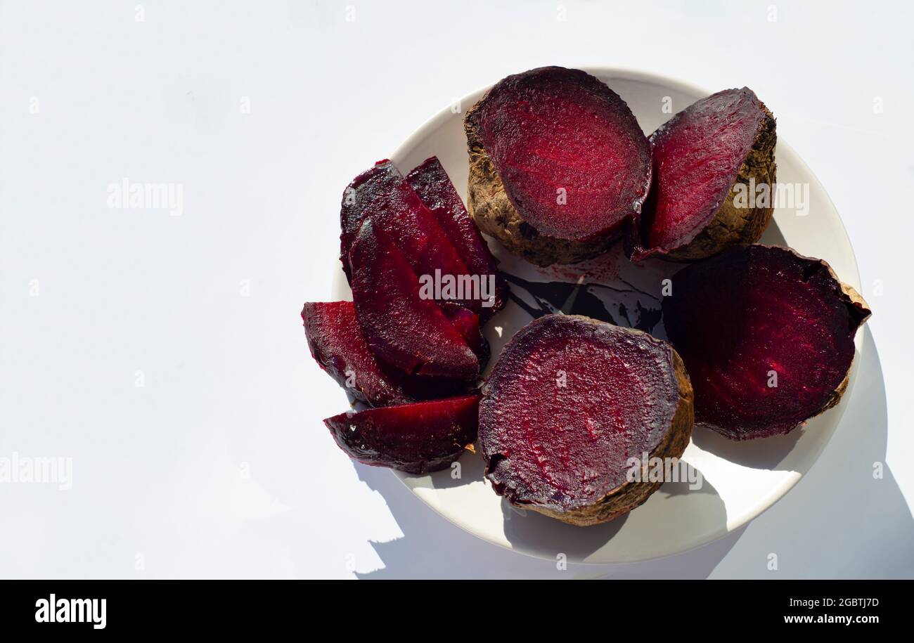 Baked beetroot. The halves are on a plate Stock Photo - Alamy