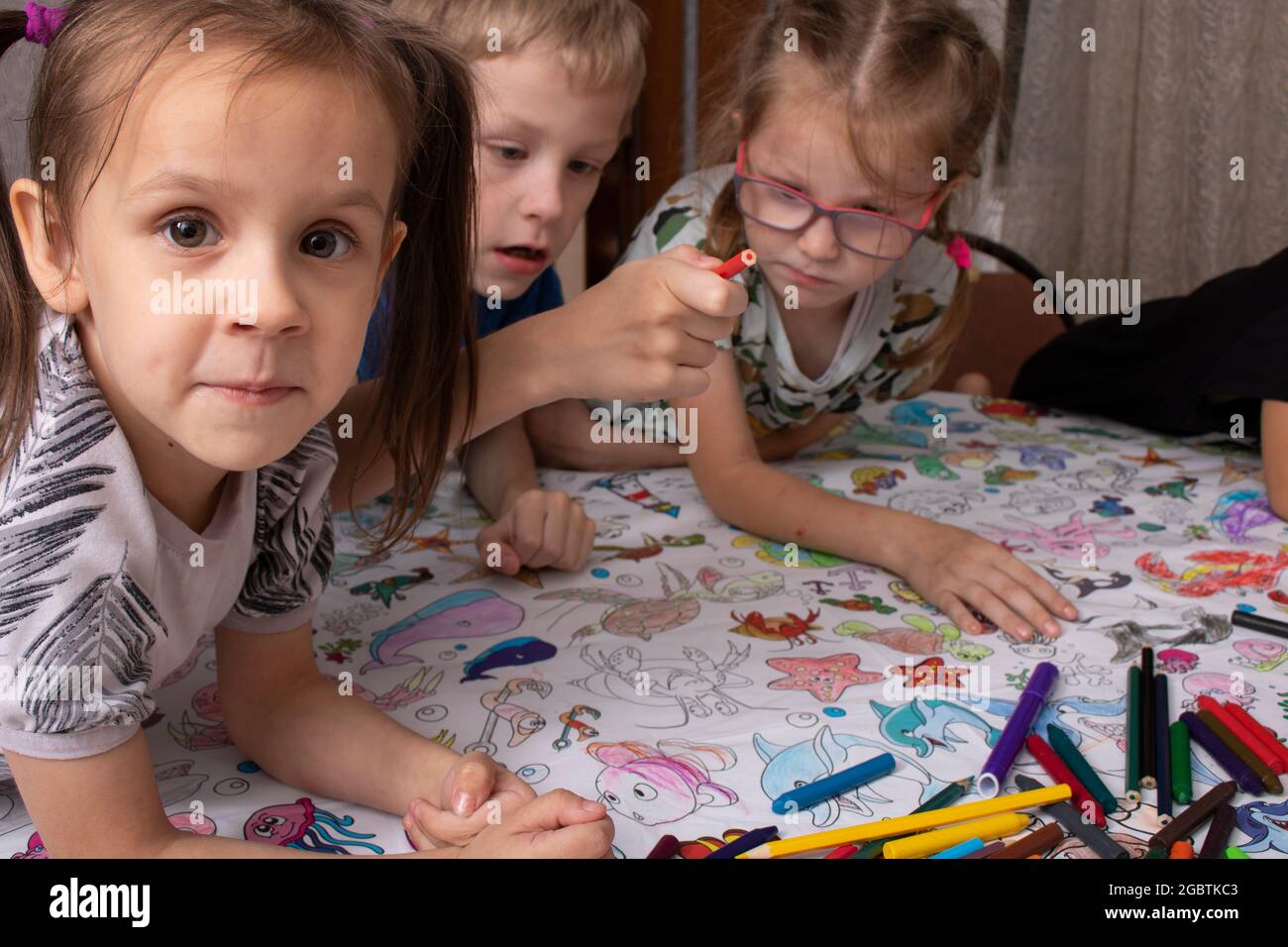 Kids painting with colorful crayons on table Stock Photo - Alamy