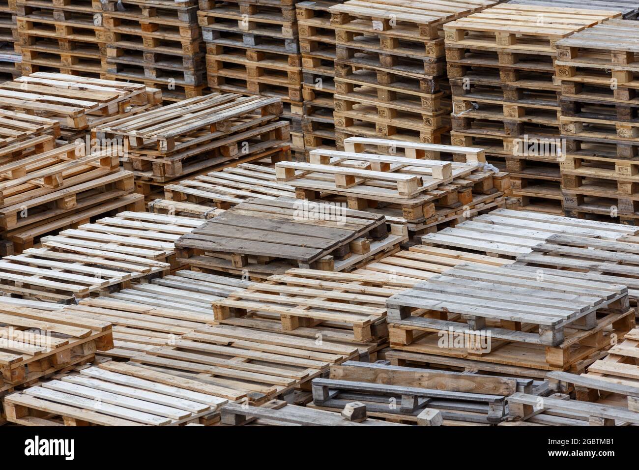 full frame background of used wooden pallet stacks - perspective view ...