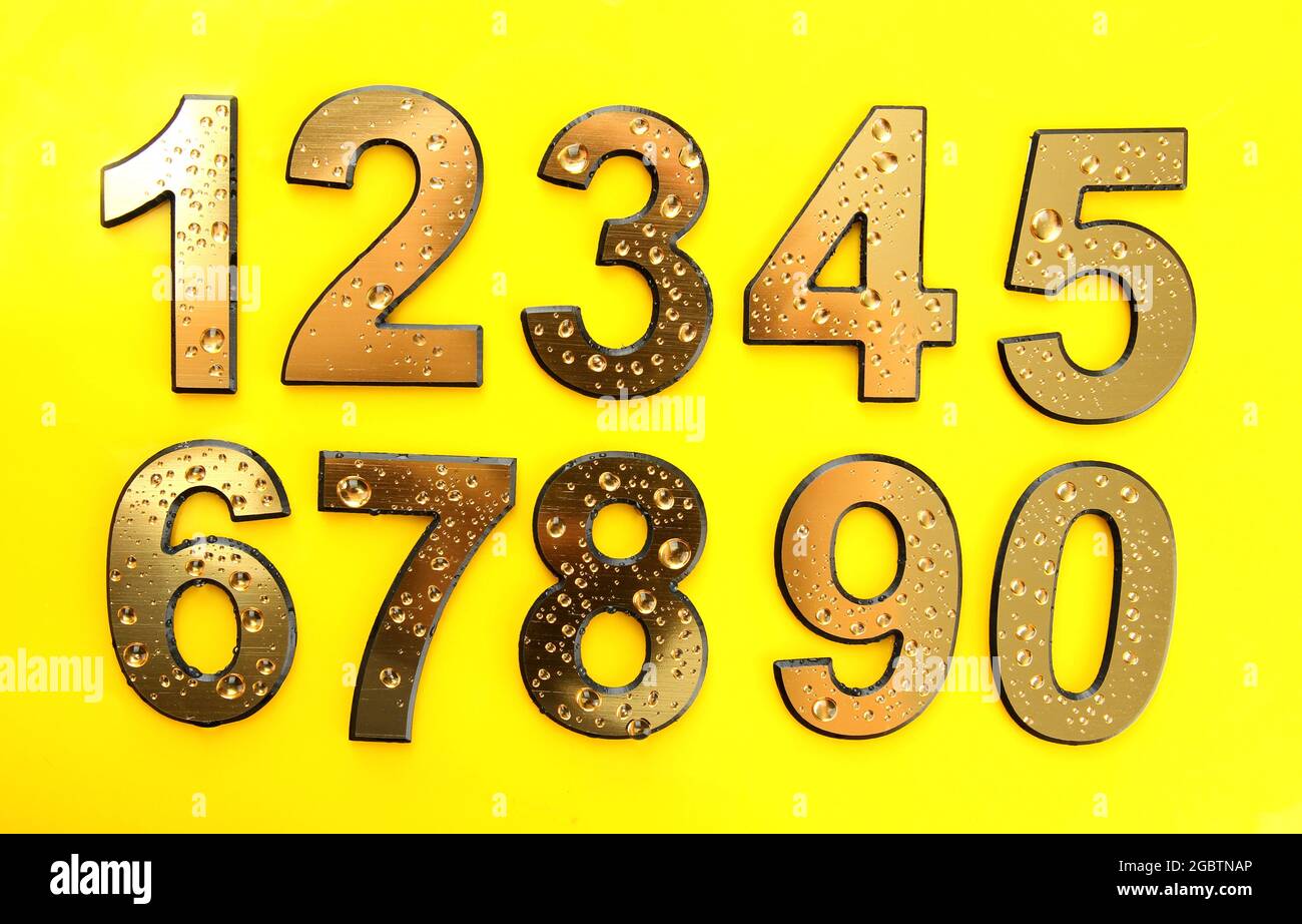 Golden numbers with drops, on yellow background Stock Photo - Alamy