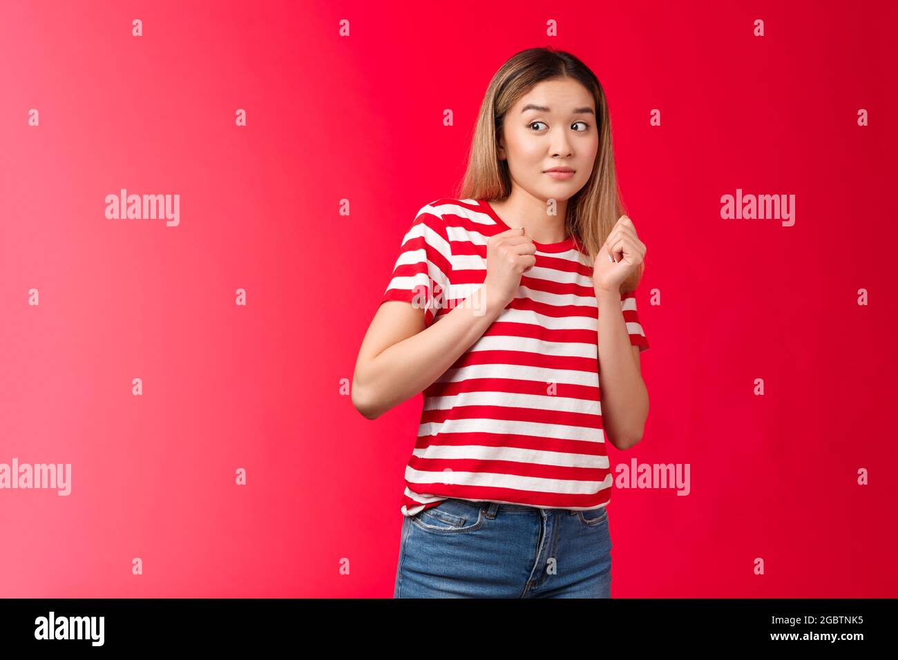 Alarmed silly blond asian girl wear striped t-shirt stay away ...