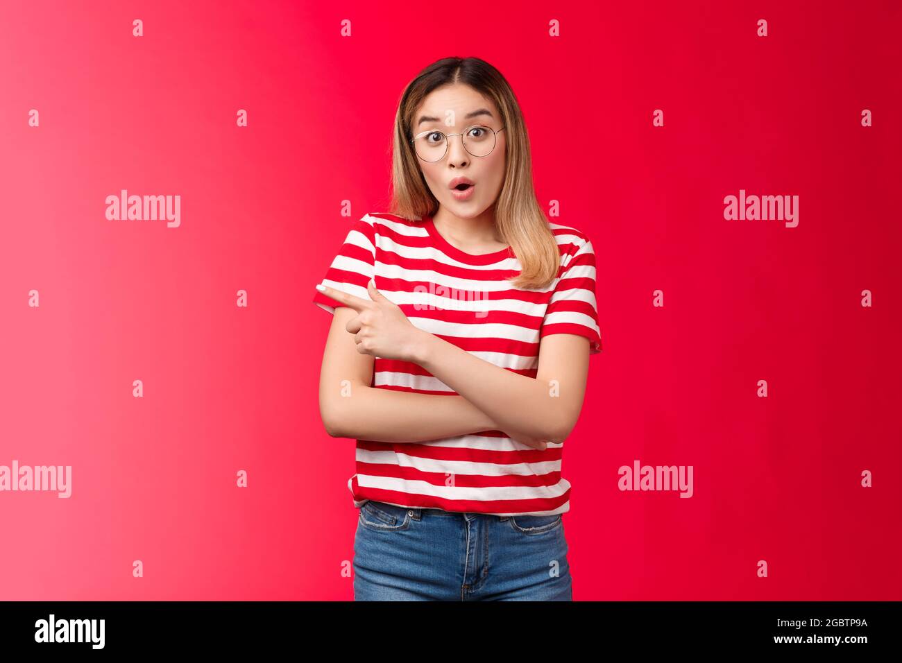 Fascinated surprised cute asian girl in glasses talking about ...