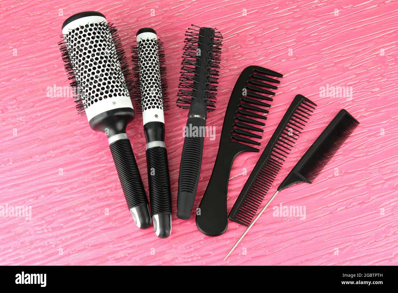 Black combs on color background Stock Photo - Alamy