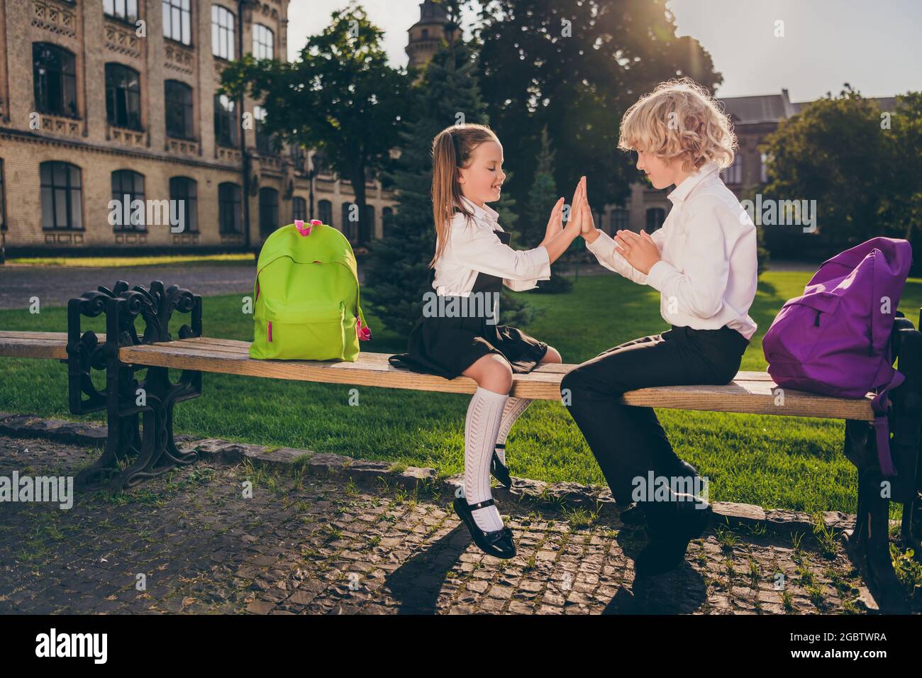 Photo of funky carefree schoolchildren sit bench play hand clapping ...