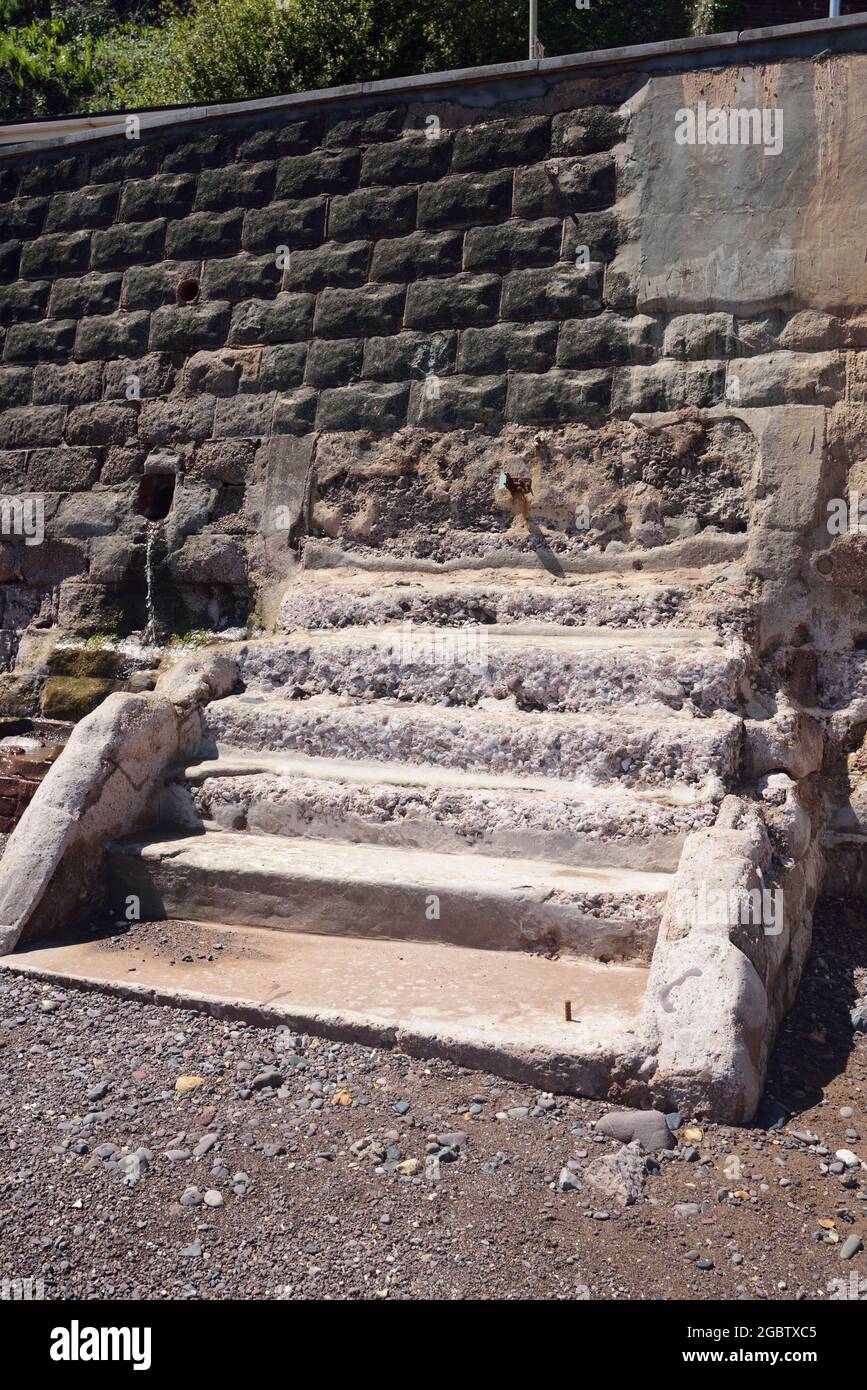 Steps to nowhere - weathered concrete steps at the base of the seawall ...