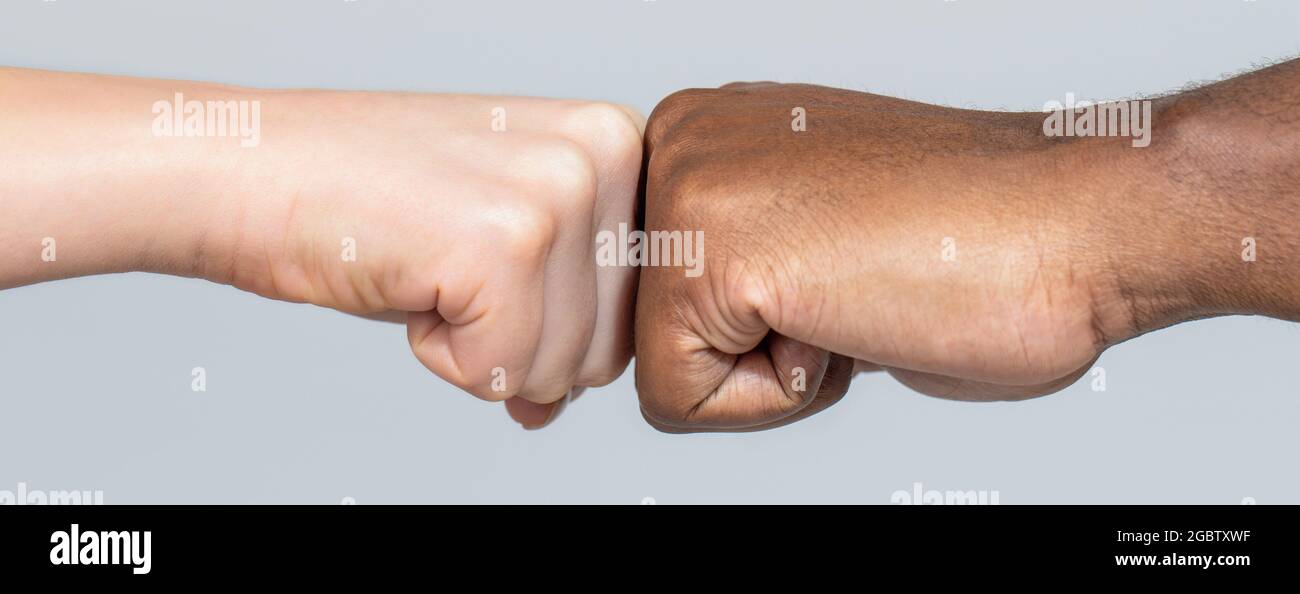Closeup of multicultural friends giving fist bump to each other. Black ...
