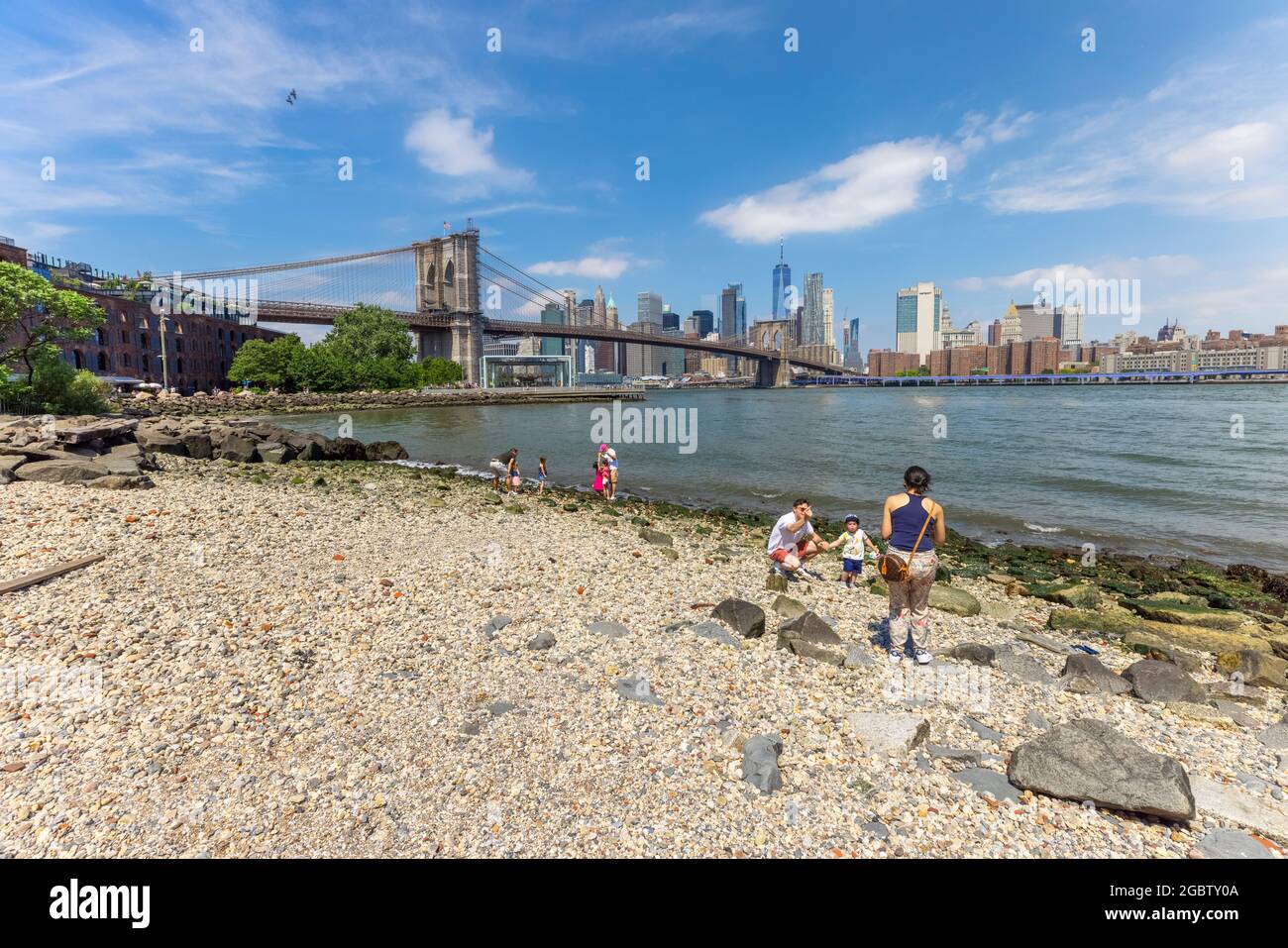 People relax on the Beach of Brooklyn Bridge Park amidst Pandemic NYC ...