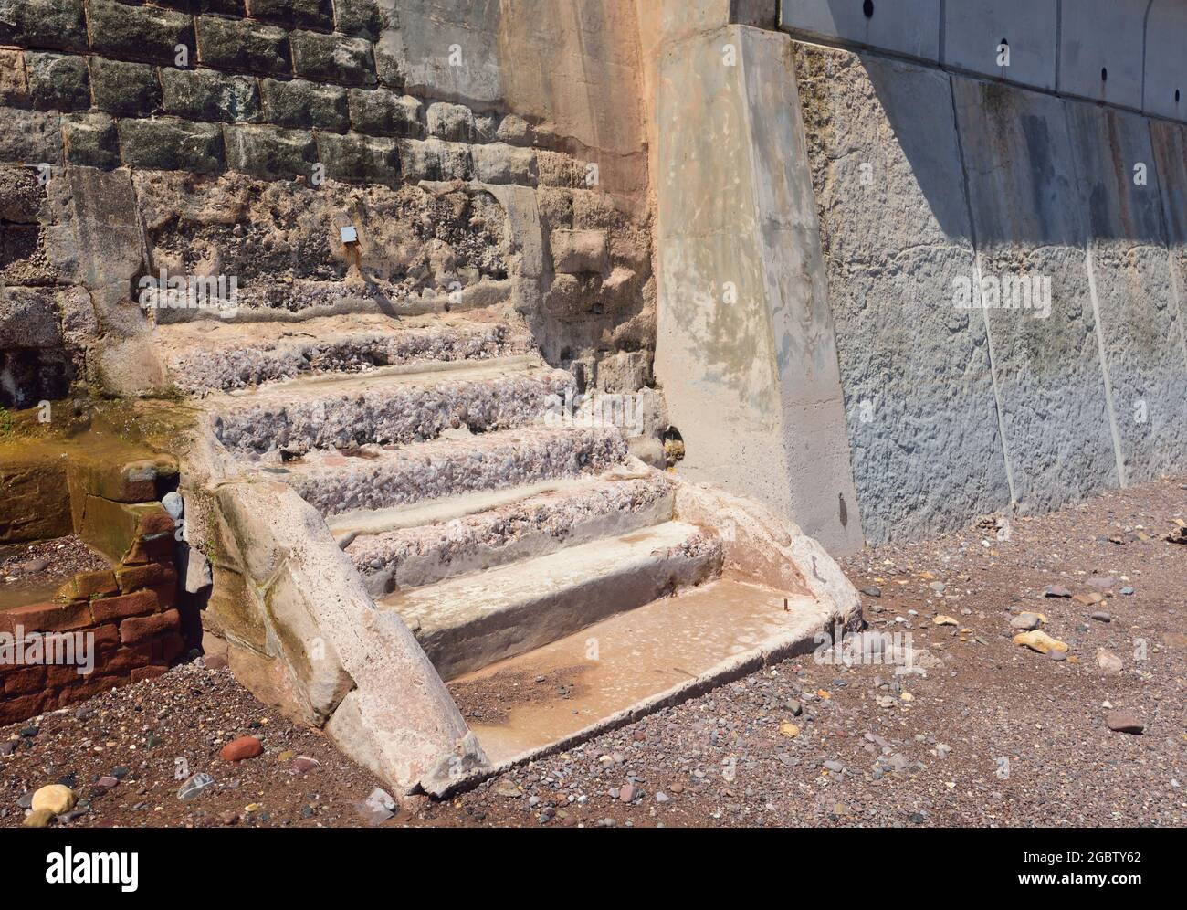 Steps to nowhere - weathered concrete steps at the base of the seawall ...