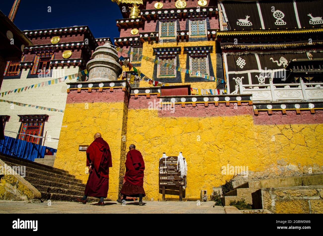Tibetan monks walking in front of monastery Stock Photo - Alamy