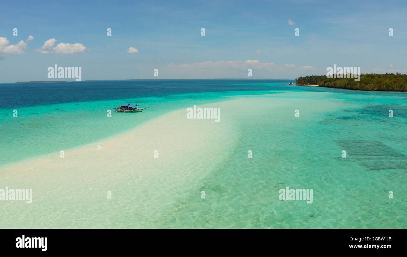Sand bar and tropical island in the clear turquoise waters of the ...