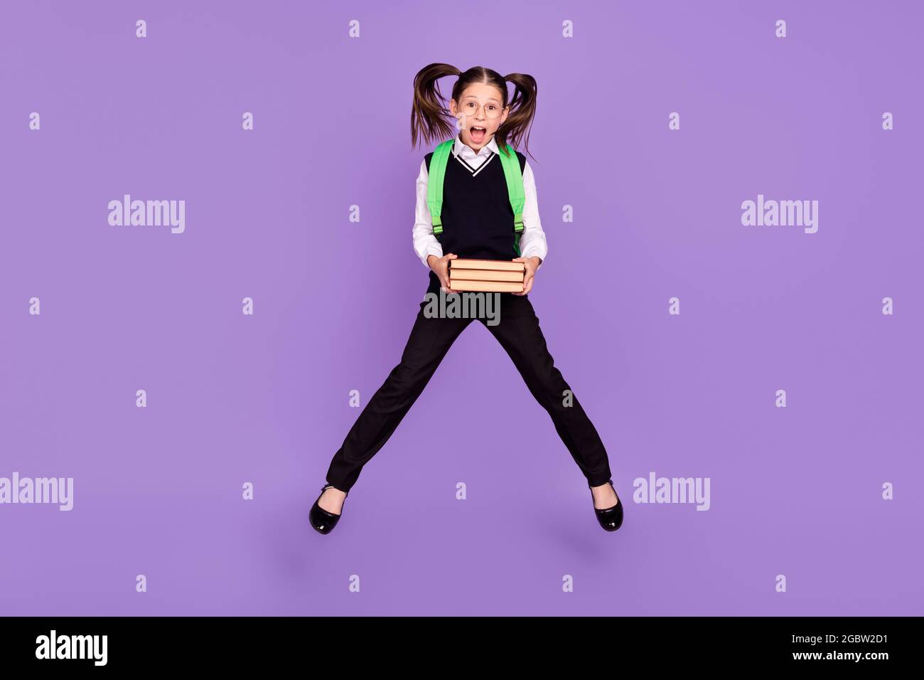 Photo of funny crazy schoolgirl jump hold pile book wear bag glasses ...