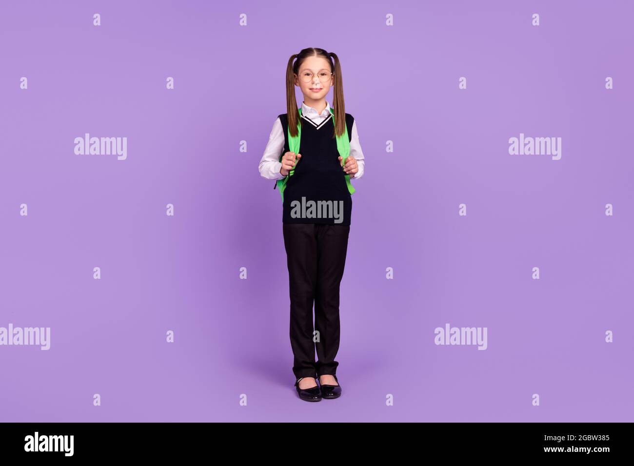 Photo of cheerful positive little schoolgirl prepare to school wear ...