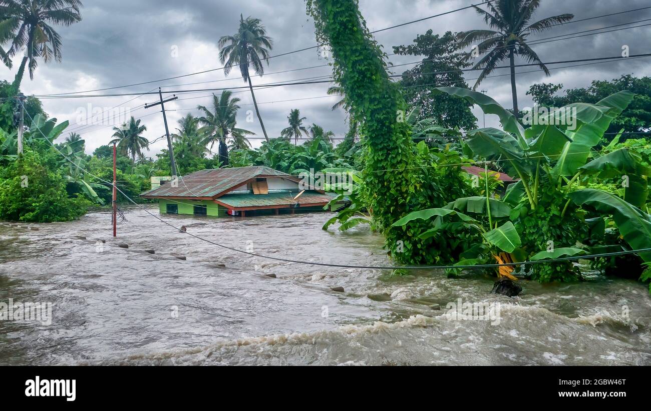 BACO, PHILIPPINES - Jul 23, 2021: Rising water levels submerge a house ...
