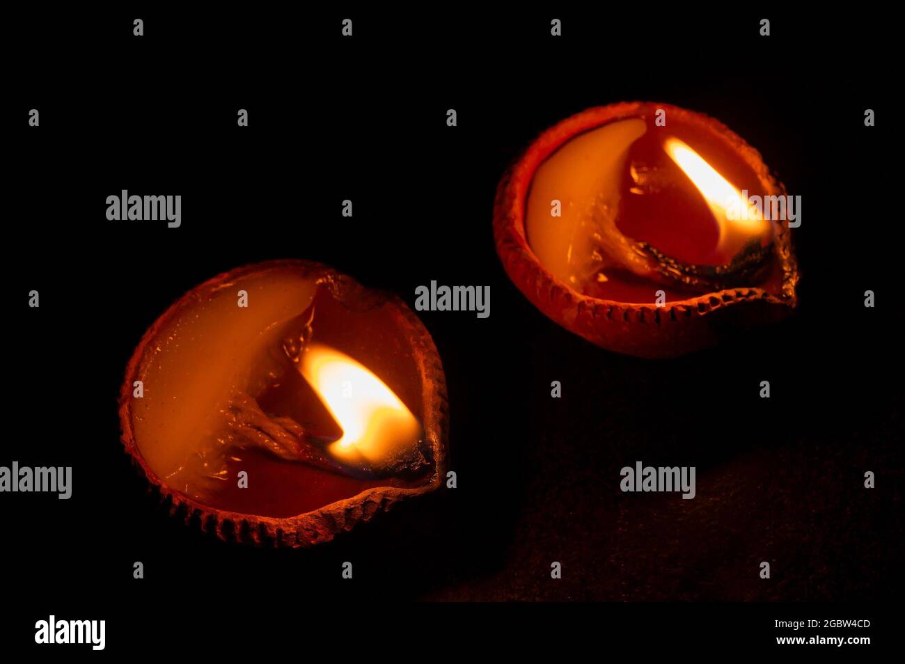 Side view of candles or diyas, Deepawali lights at night. Dark ...