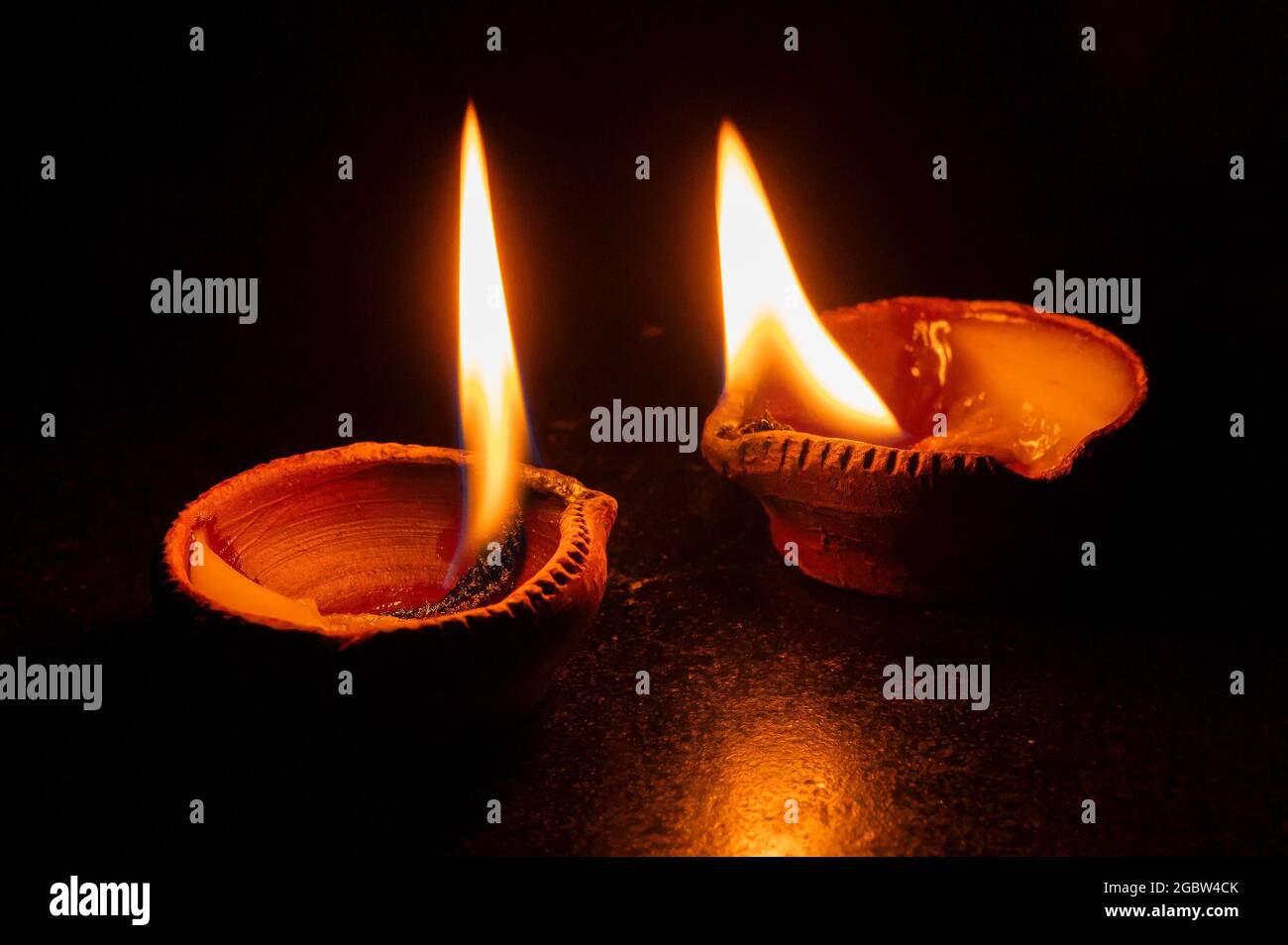 Side view of candles or diyas, Deepawali lights at night. Dark ...