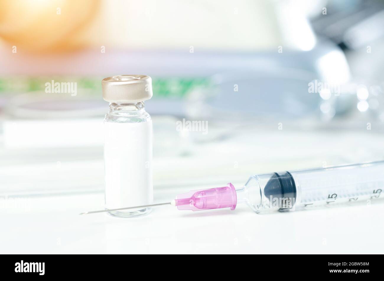 Vaccine COVID-19 . Syringe and blue vaccine vial, bottle of medicine ...