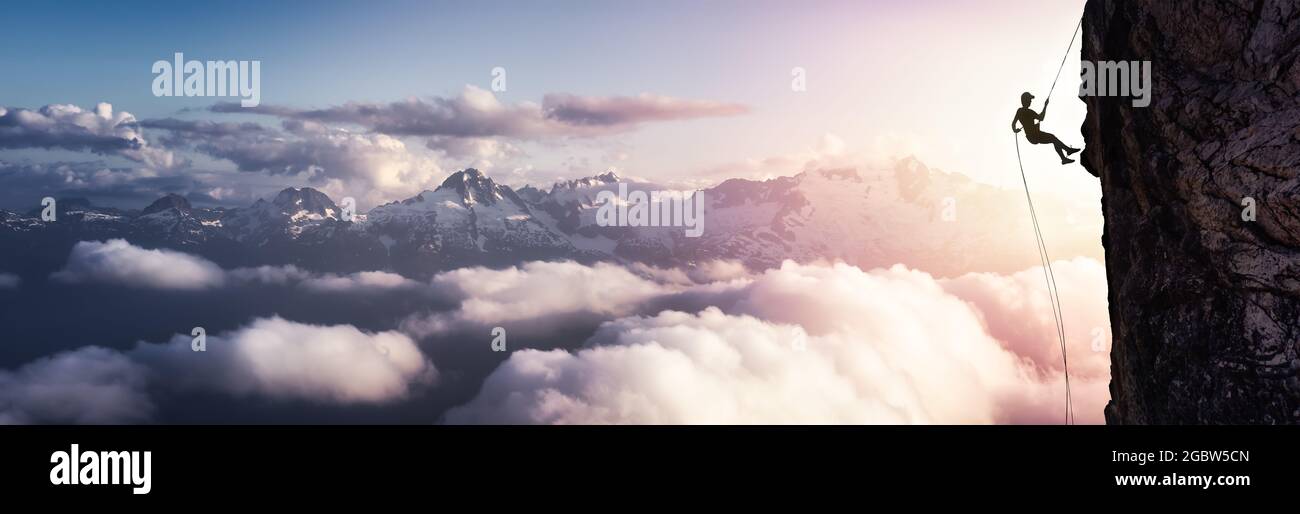Silhouette Rappelling from Cliff Stock Photo - Alamy