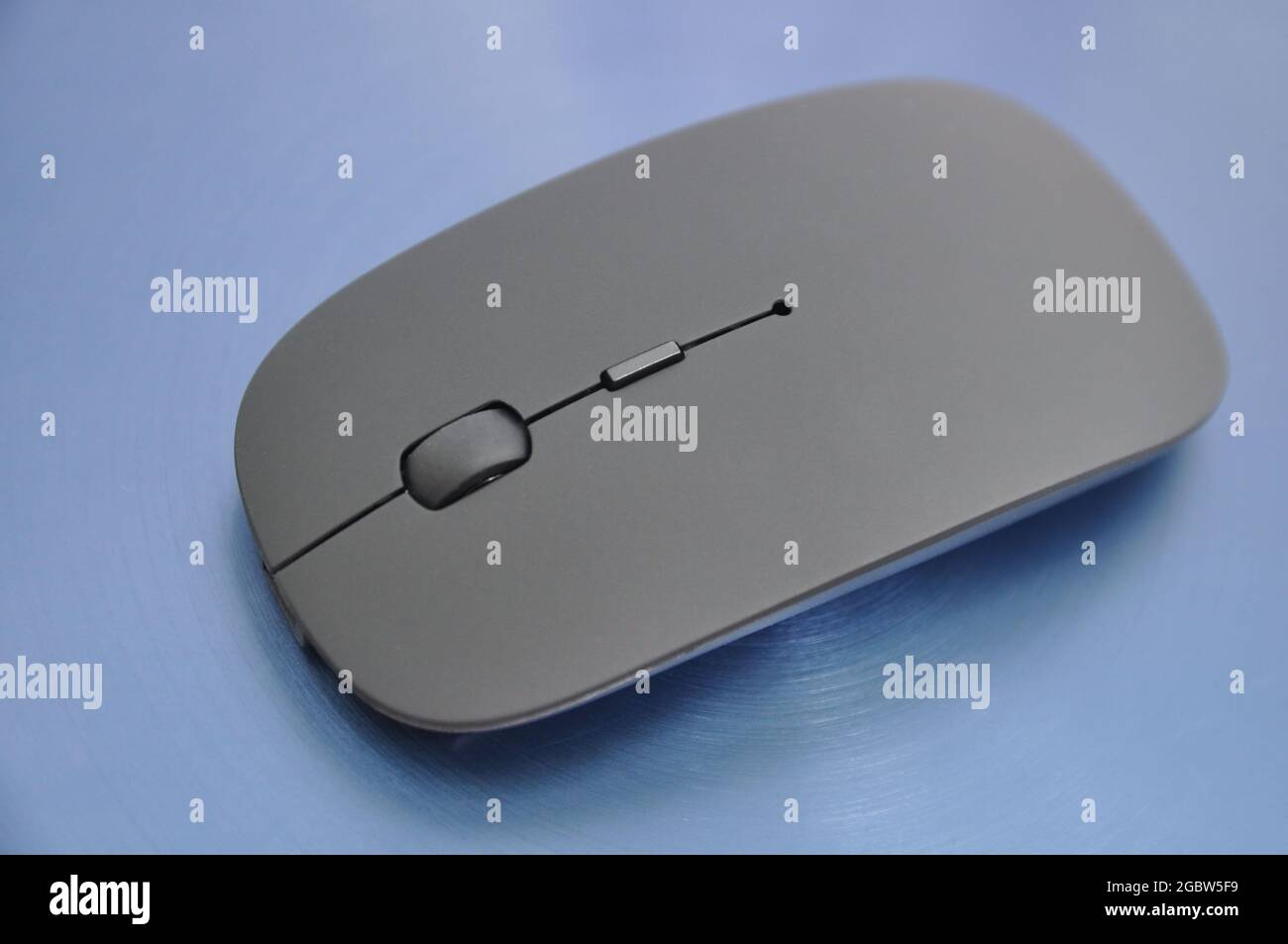 Wireless rechargeable computer mouse on a blue background. Technology ...