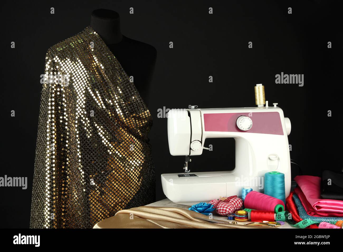 Sewing machine, dummy and other sewing equipment isolated on black ...