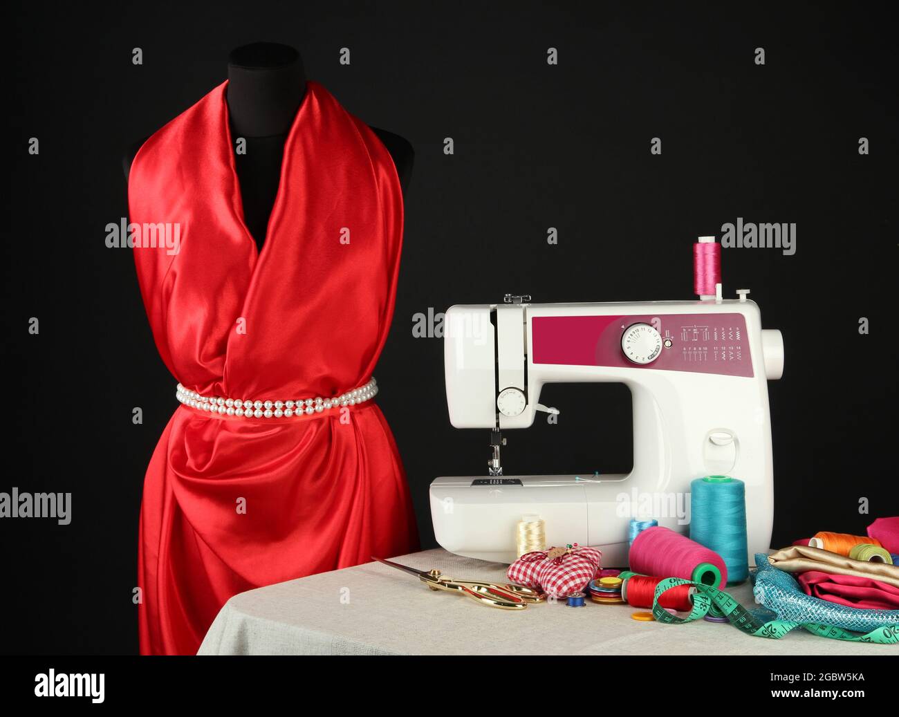 Sewing machine, dummy and other sewing equipment isolated on black ...