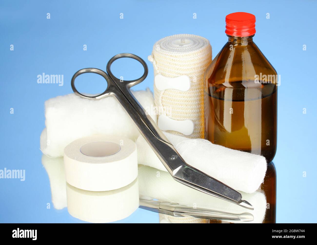 First aid kit for bandaging on blue background Stock Photo - Alamy