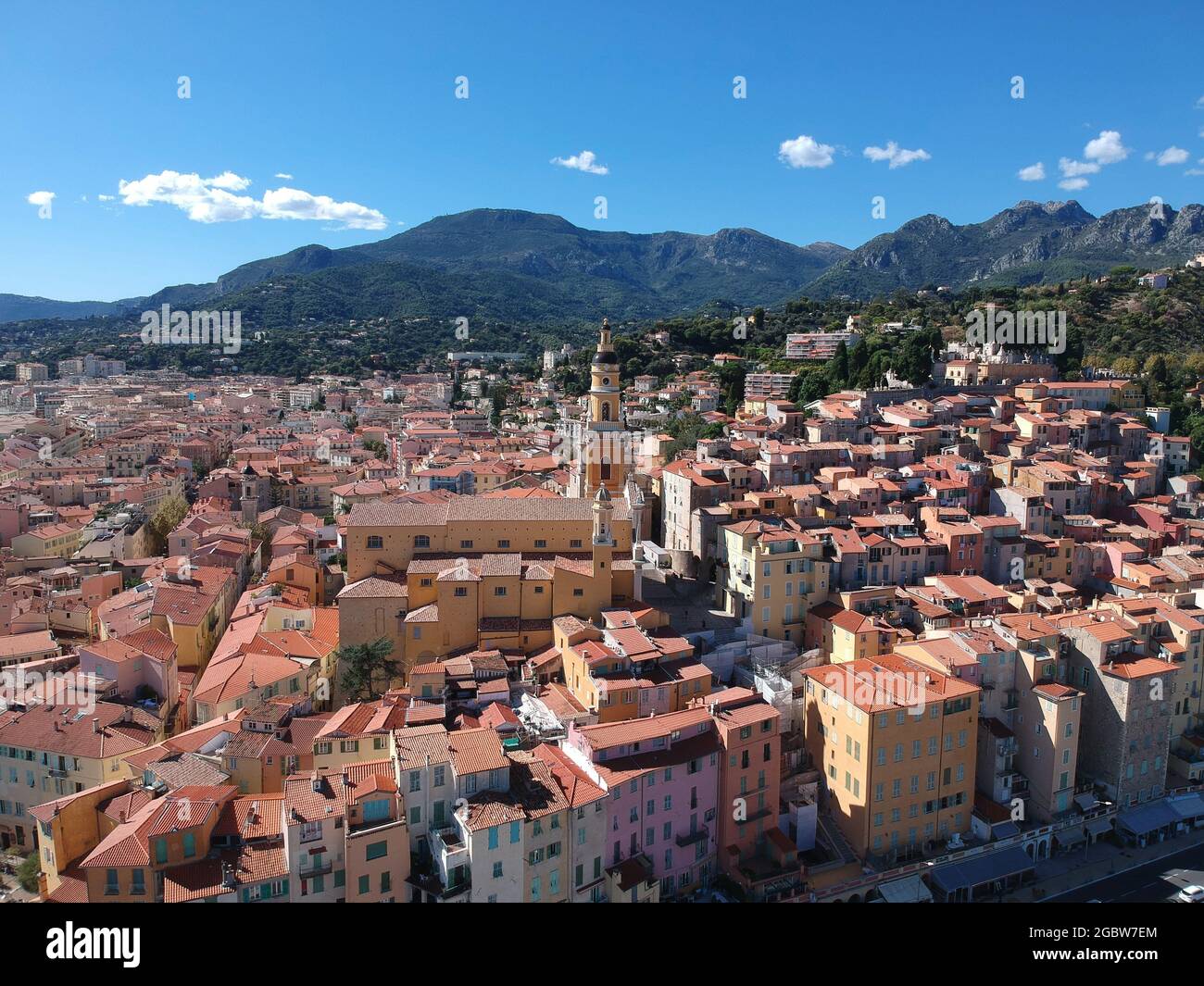 Aerial view of dense buildings and mountains under a clear sky in ...