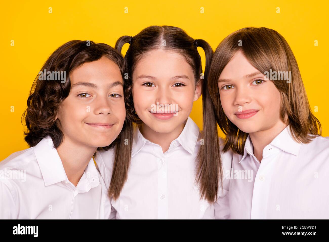 Photo of three cute peaceful kids lean together posing wear white shirt ...