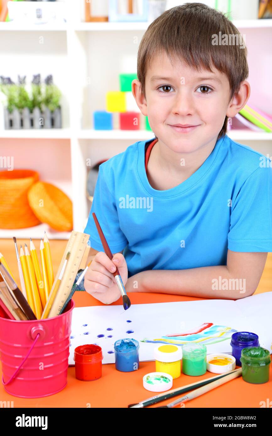 Cute little boy painting in his album Stock Photo - Alamy
