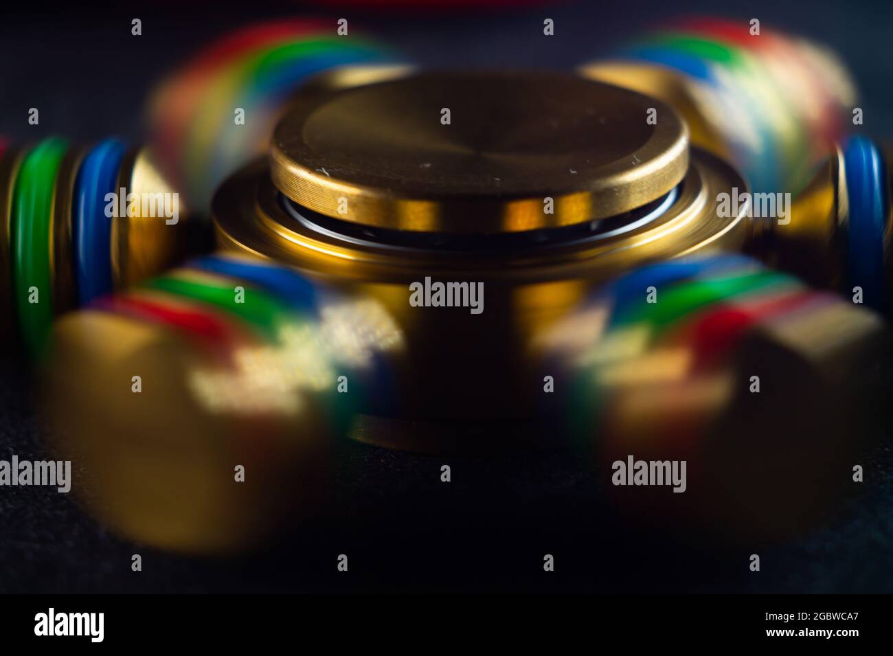 Closeup shot of a metallic colorful spinner rotating Stock Photo - Alamy