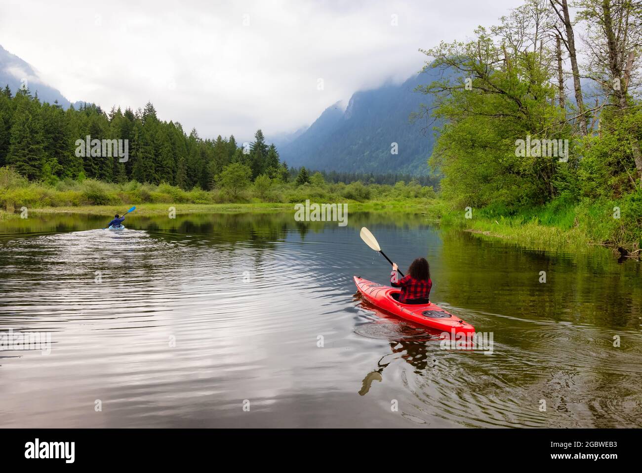 Adventure Caucasian Adult Woman Kayaking in Red Kayak Stock Photo - Alamy