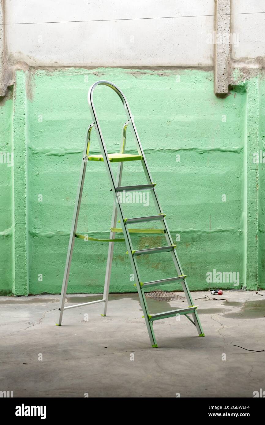 Aluminum and plastic folding ladder in green color Stock Photo - Alamy