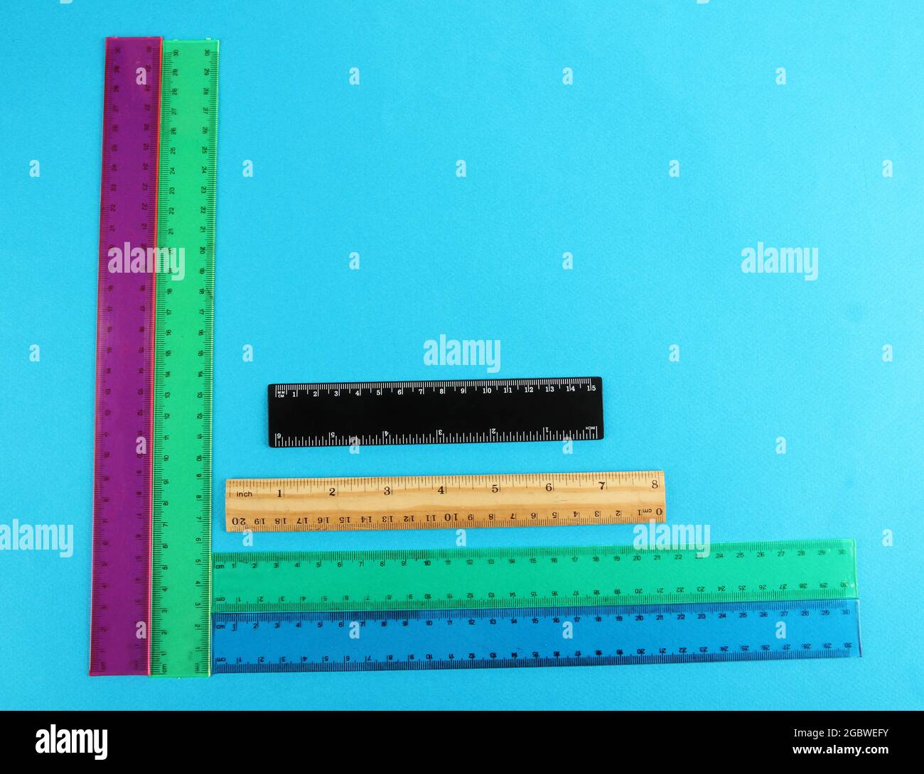Rulers on blue background Stock Photo - Alamy