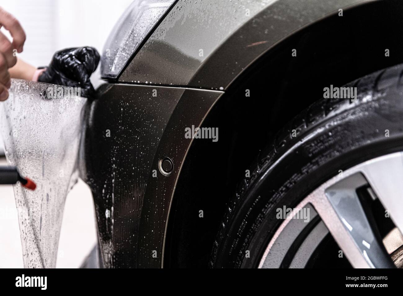 Installation of car transparent ppf foil in detailing studio Stock ...