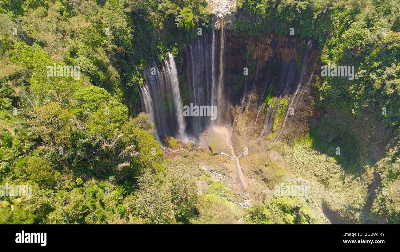 beautiful waterfall Coban Sewu in tropical forest, Java Indonesia ...
